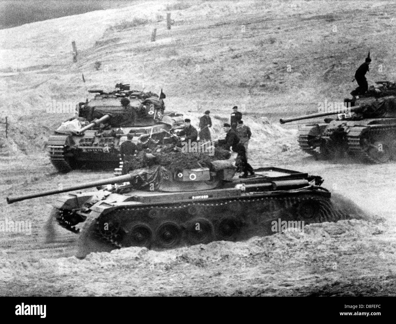 Three Centurion tanks of the British army drive across an obstacle ...
