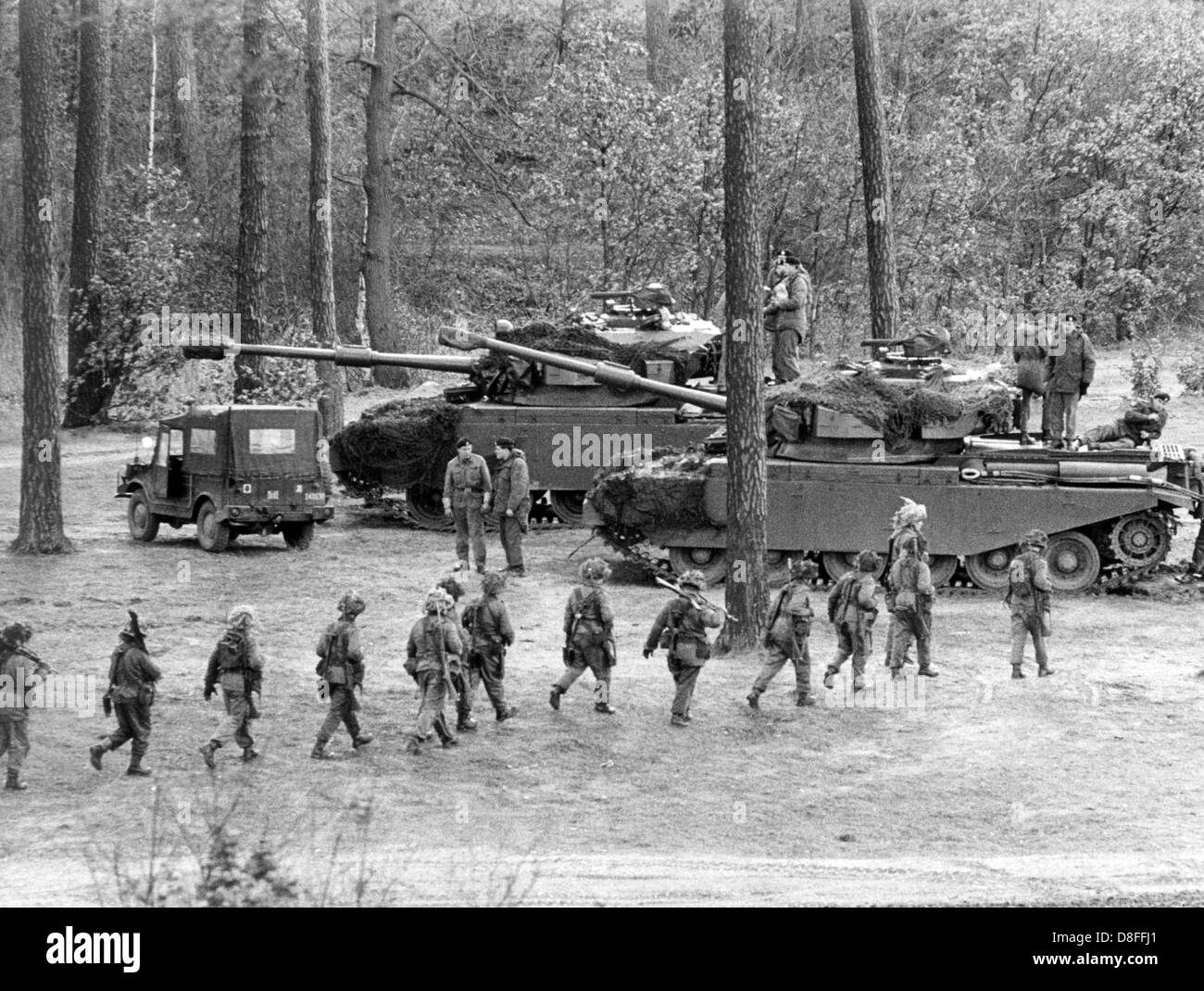 On 11 February 1964, British and French soldiers pass two heavy tanks ...
