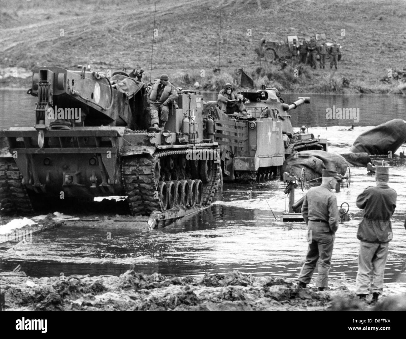 Soldiers of the US army try to recover a ferry which has sunk in the ...