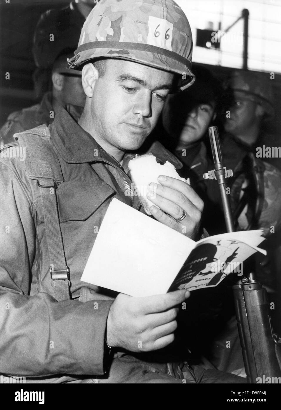 A soldier of the US army is reading a book about German habits during ...
