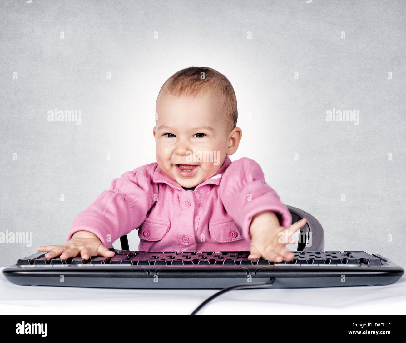 Baby typing with hands. Left hand blured in move Stock Photo - Alamy