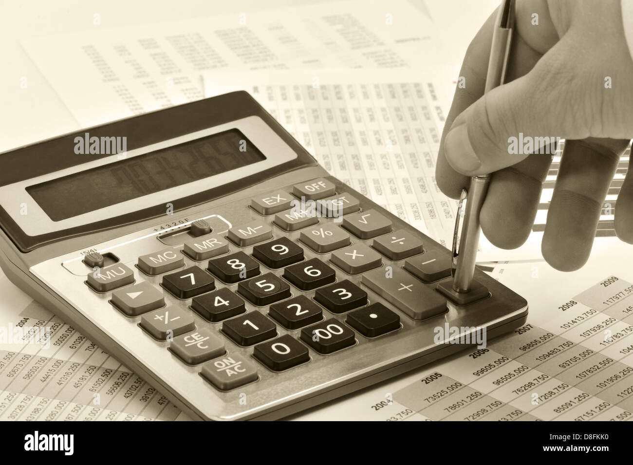 The calculator and a hand of the man Stock Photo - Alamy