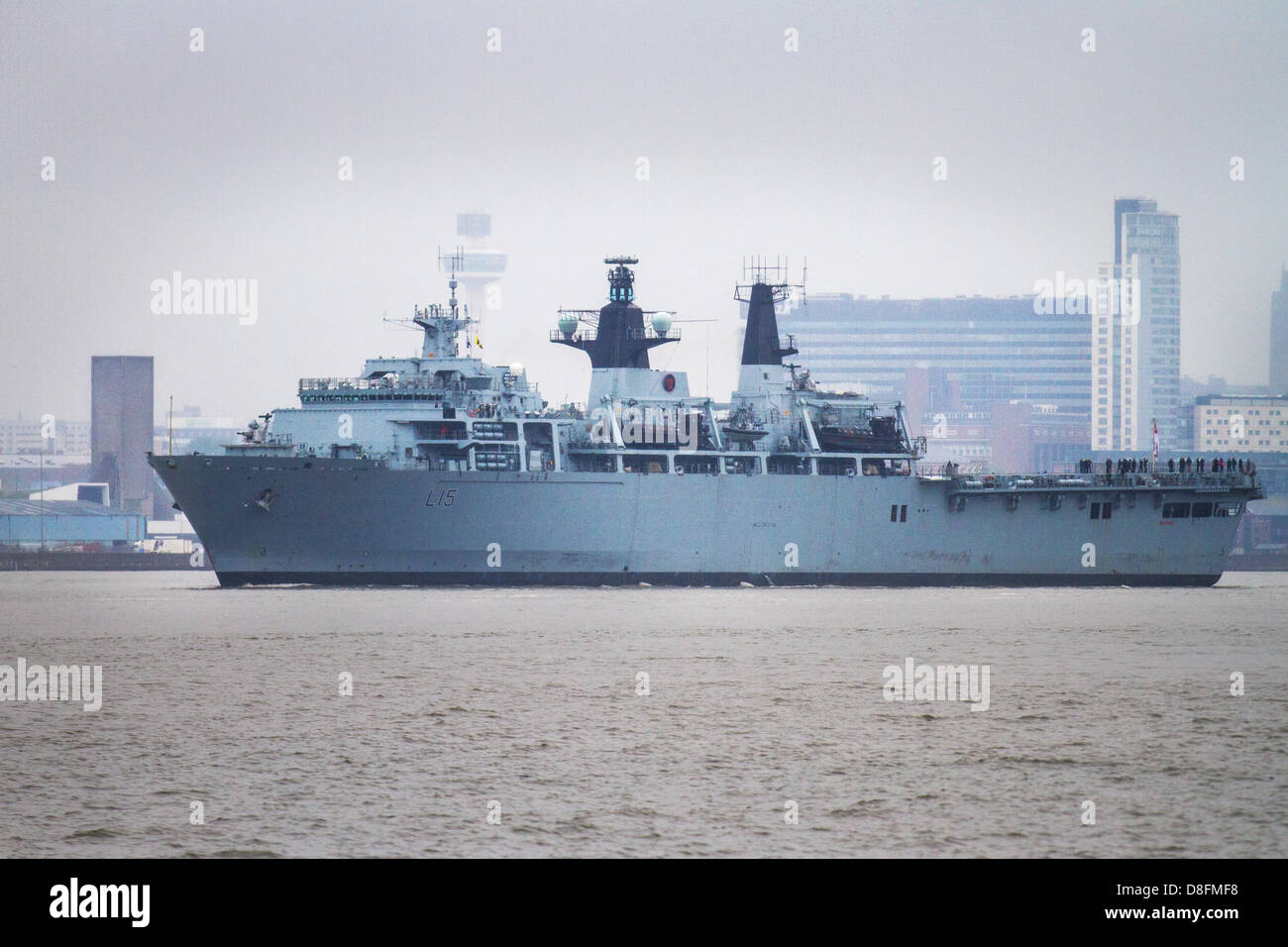 The departure of the HMS Bulwark, in rain and mist, as the navy ...