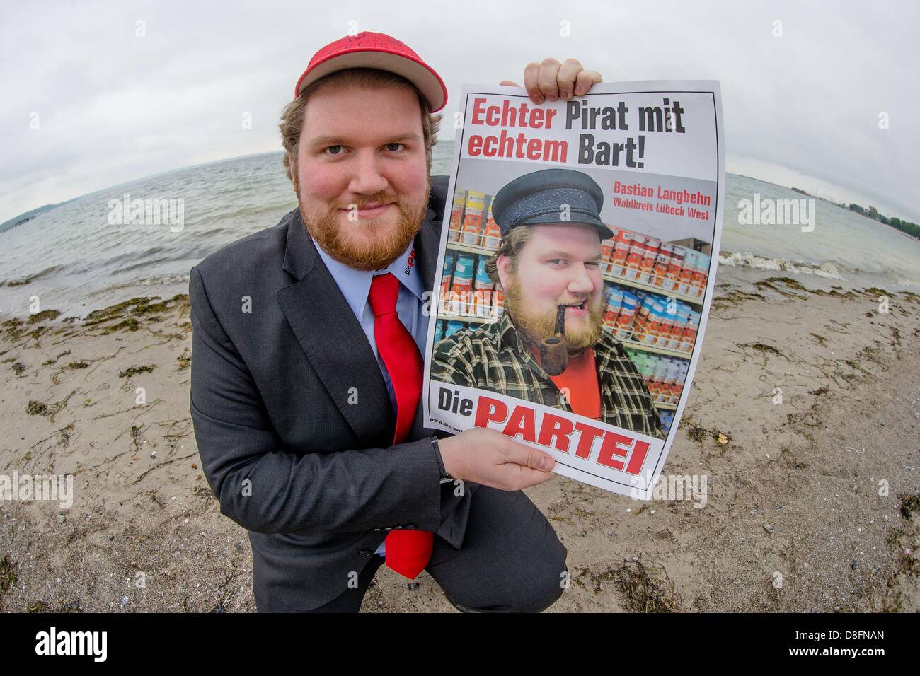 Bastian Langbehn, member of "Die Partei" poses with an election poster ...
