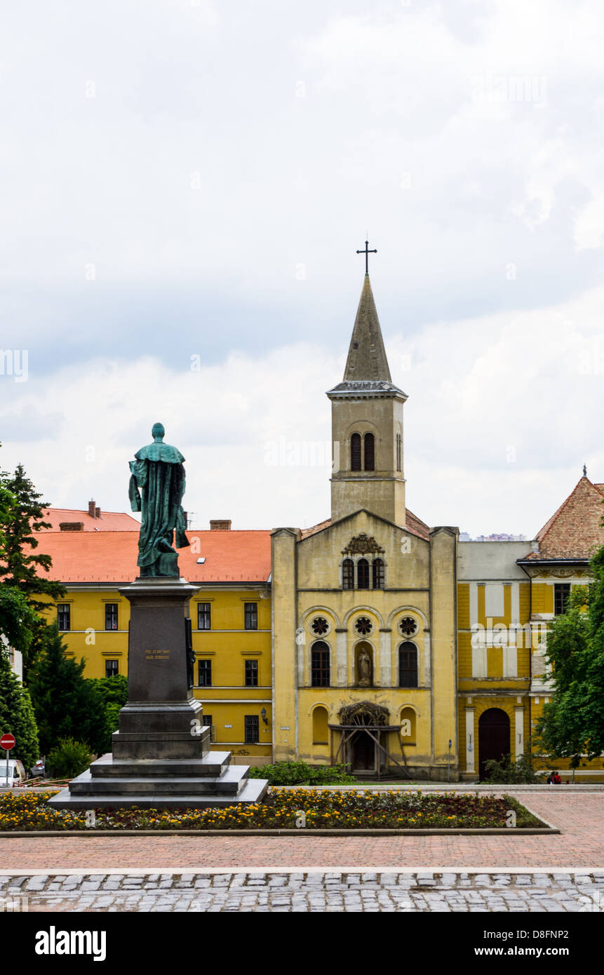 A monument and an old church in Pecs, Hungary Stock Photo - Alamy