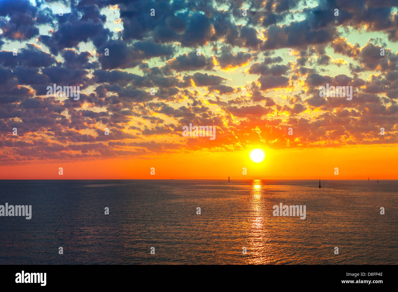 Reflection of the sun at sunrise at sea Stock Photo - Alamy