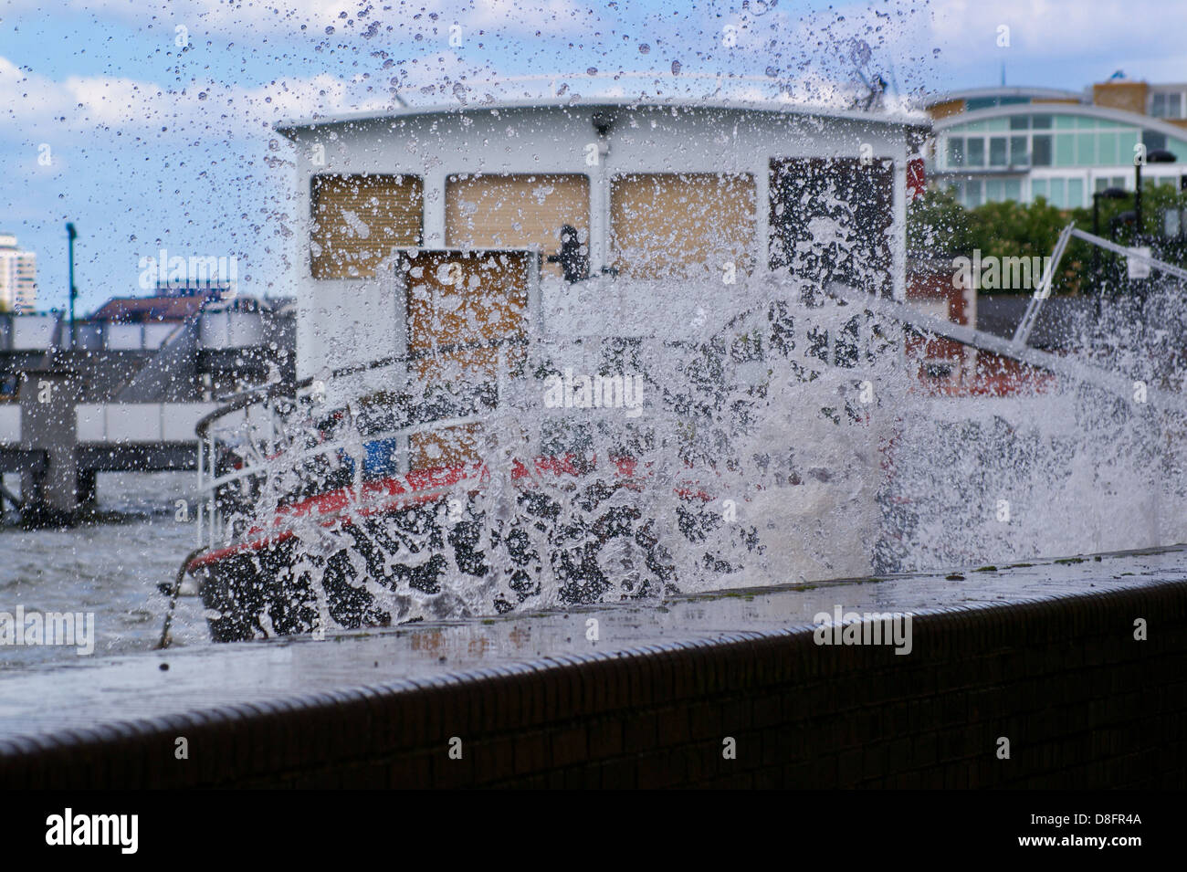 Waves breaking on the sea wall on the Thames in London Stock Photo - Alamy