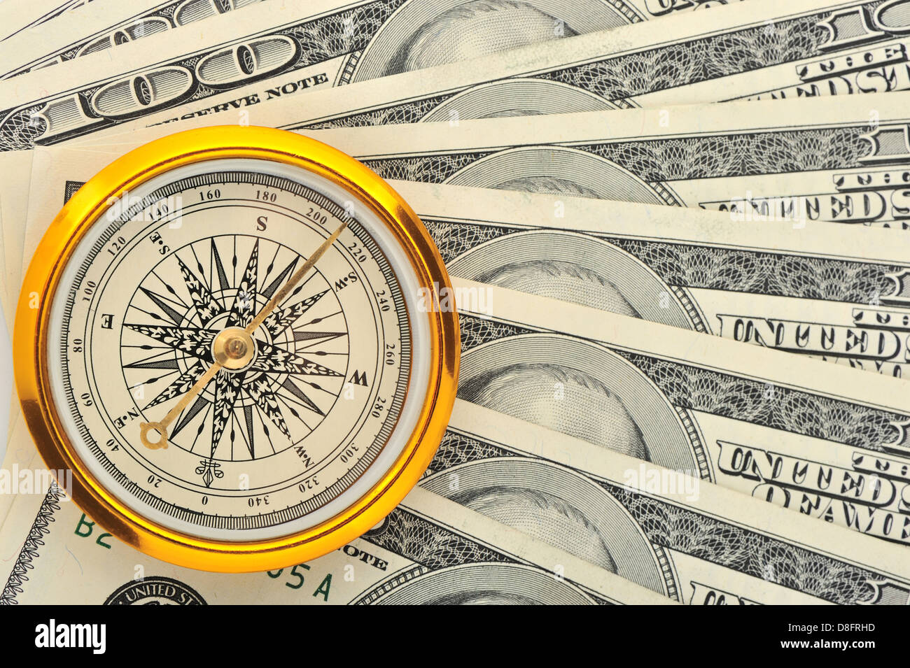Dollars and compass Stock Photo - Alamy