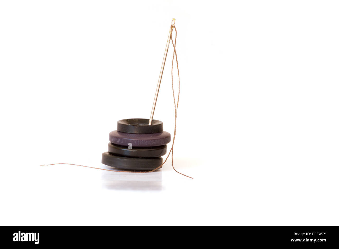 Close up of needle, thread and buttons on a white background Stock ...