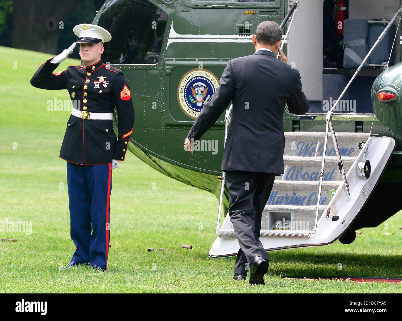 United States President Barack Obama salutes the Marine Guard as he ...