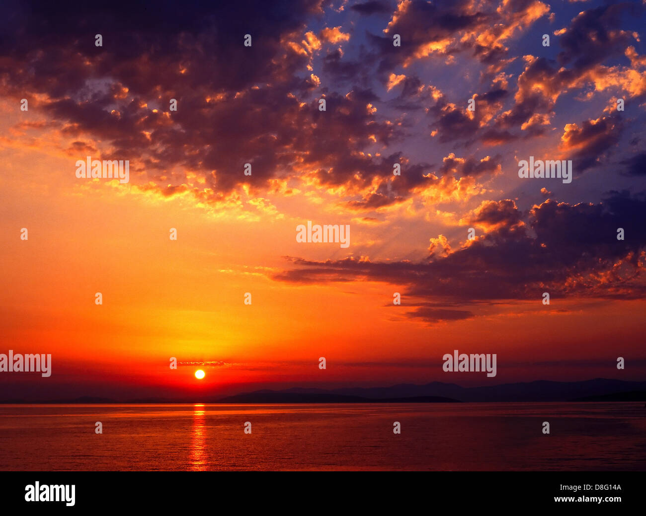 Sunset on the sea with clouds Stock Photo - Alamy