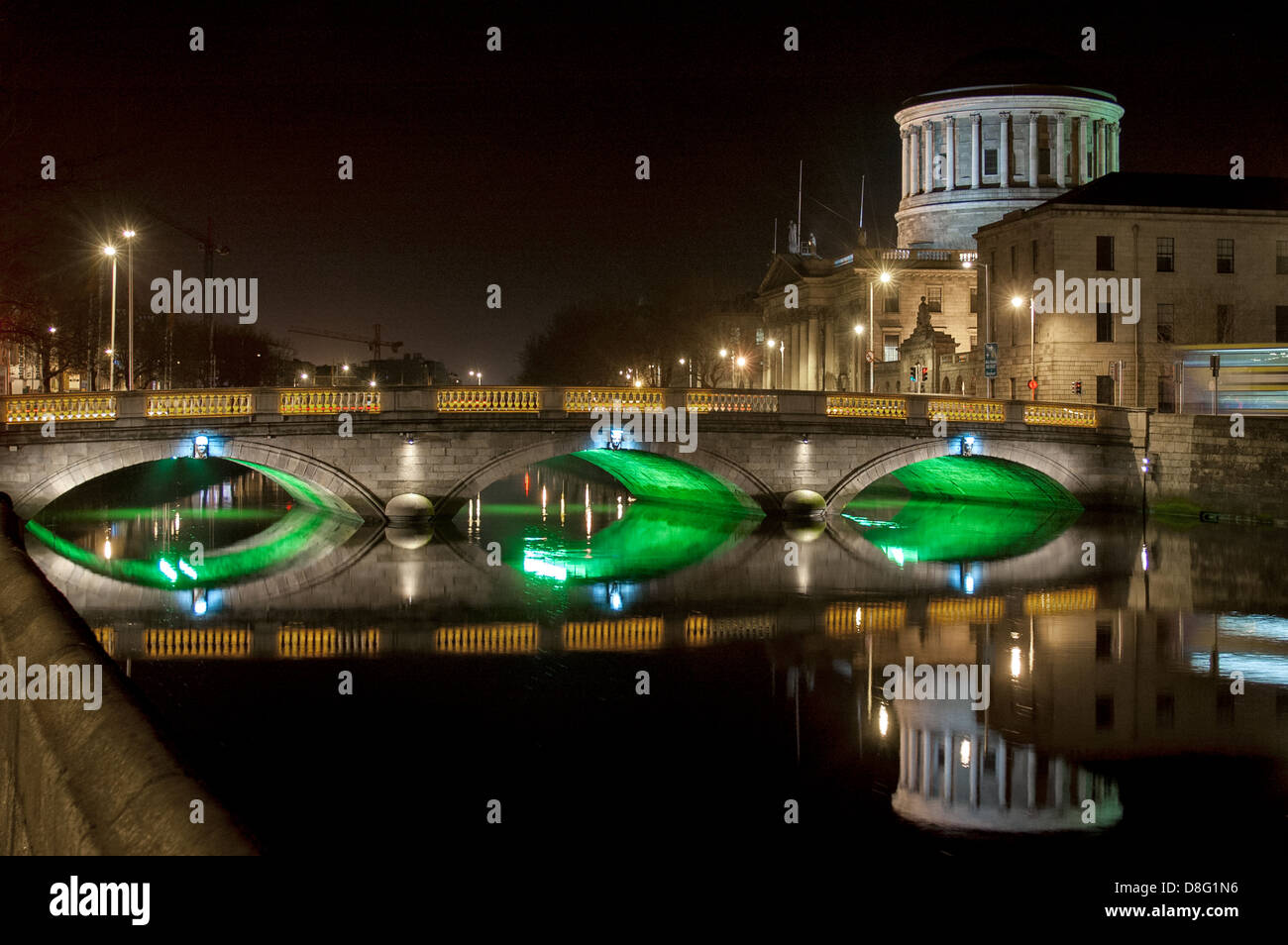 A bridge across the River Liffey in Dublin, Ireland is illuminated with ...