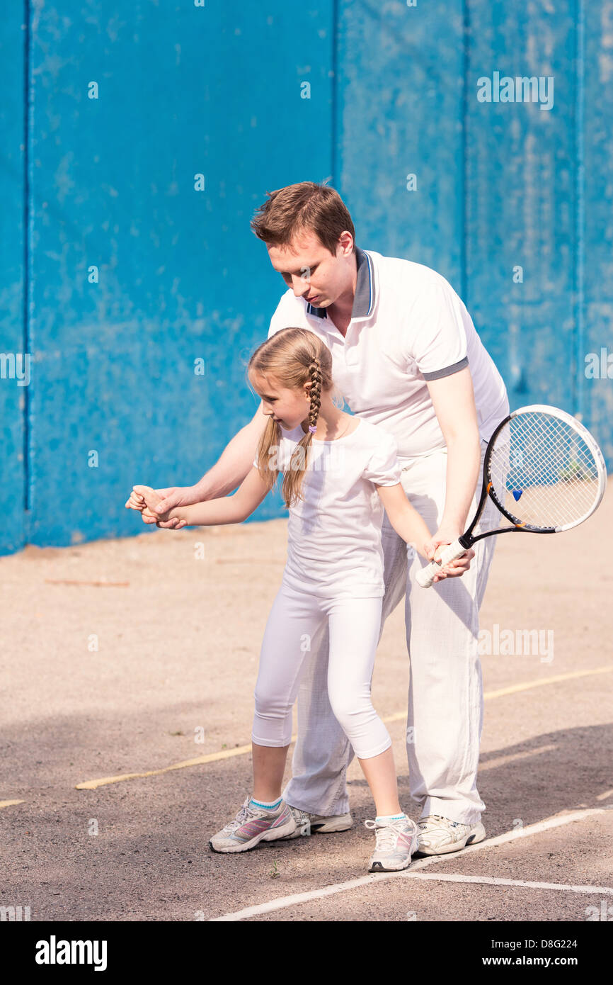 Trainer teaching child to play tennis hi-res stock photography and ...