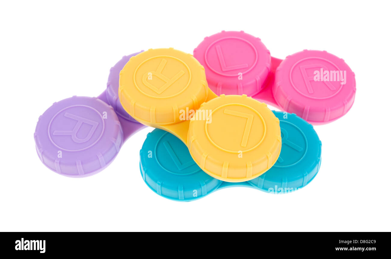 Four colorful contact lens cases with covers attached on a white ...