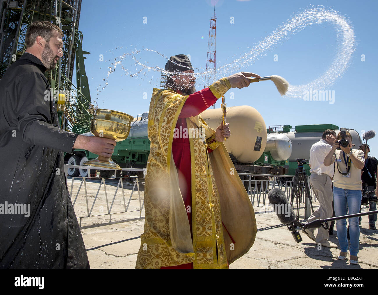 A Russian Orthodox Priest blesses members of the media shortly after ...