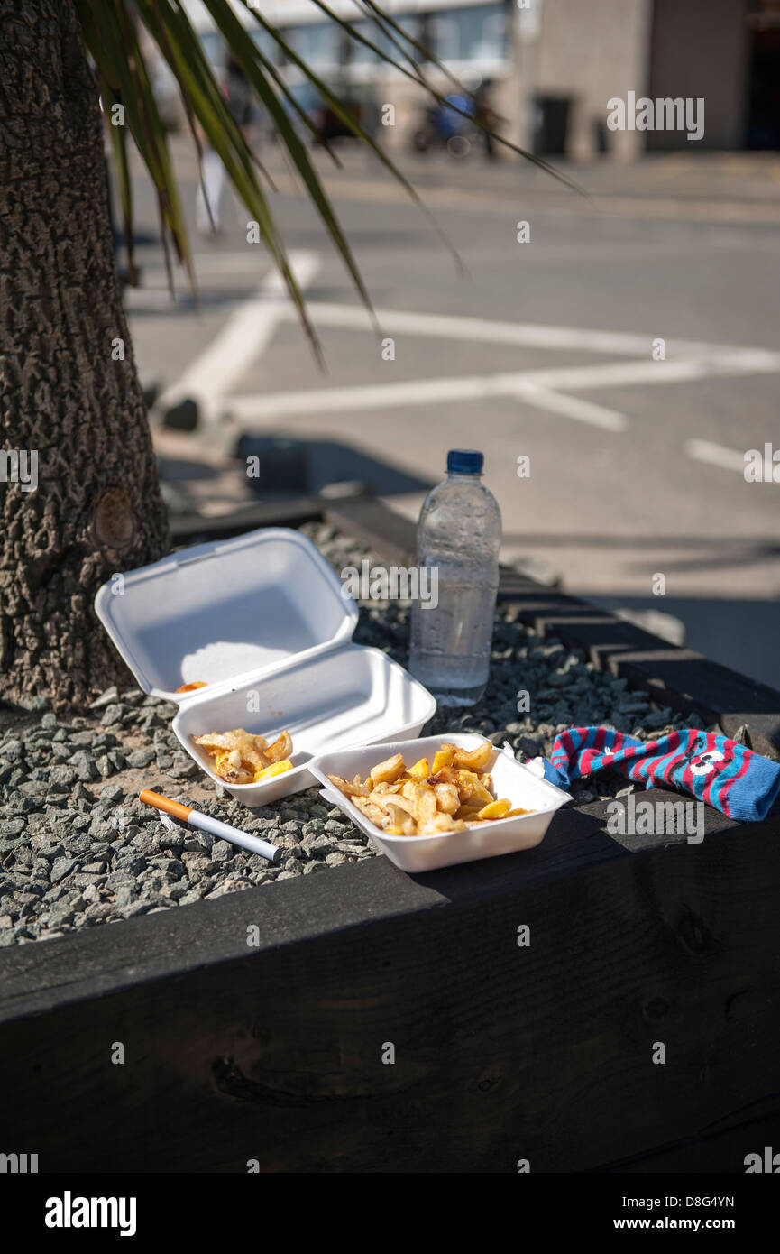 Leftover fish and chips, discarded electronic cigarette on seafront ...