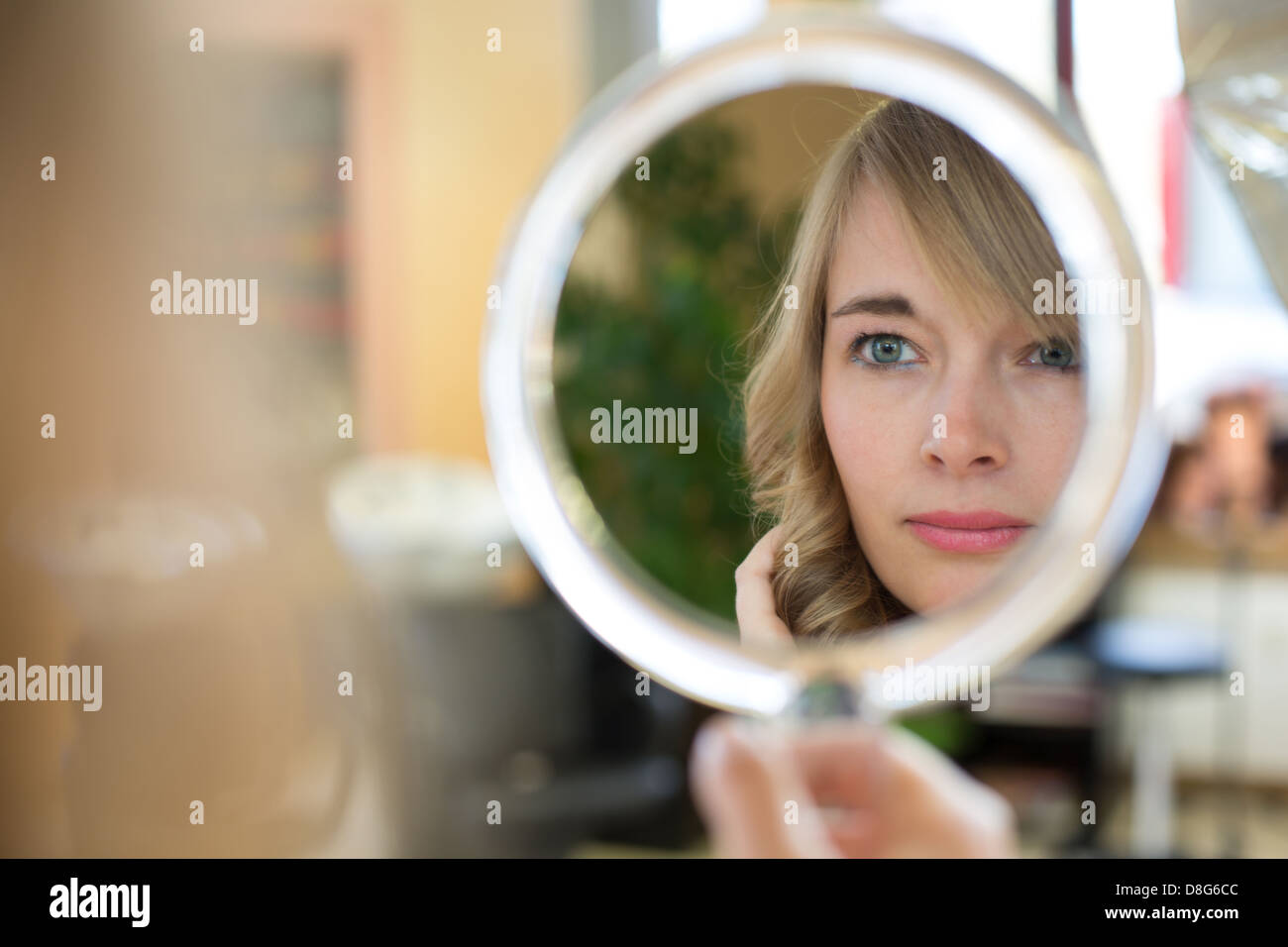 customer looking ar her new haircut in mirror Stock Photo - Alamy