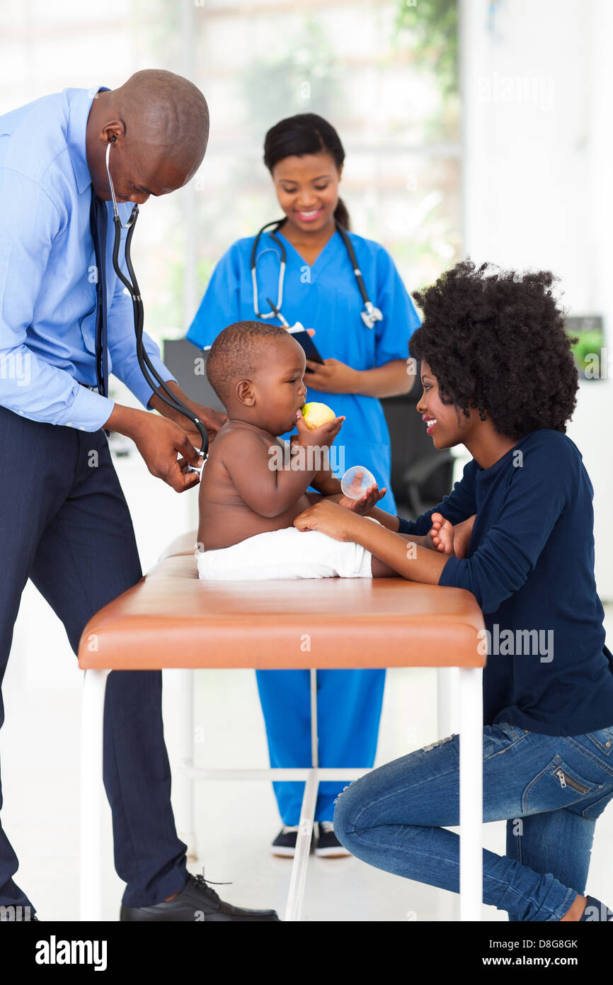 male African American pediatrician examining baby boy Stock Photo - Alamy