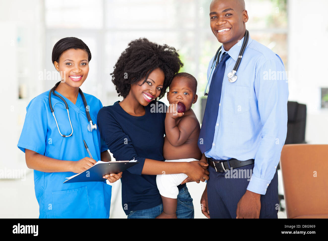 smiling pediatric medical professionals with african mother holding her ...