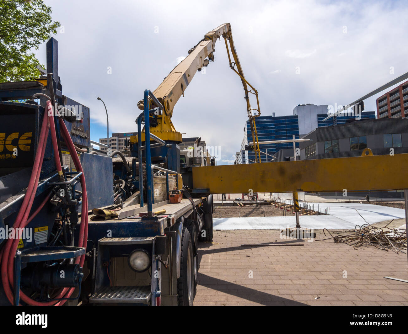 concrete pouring vehicle with long arm on construction site in Stock ...