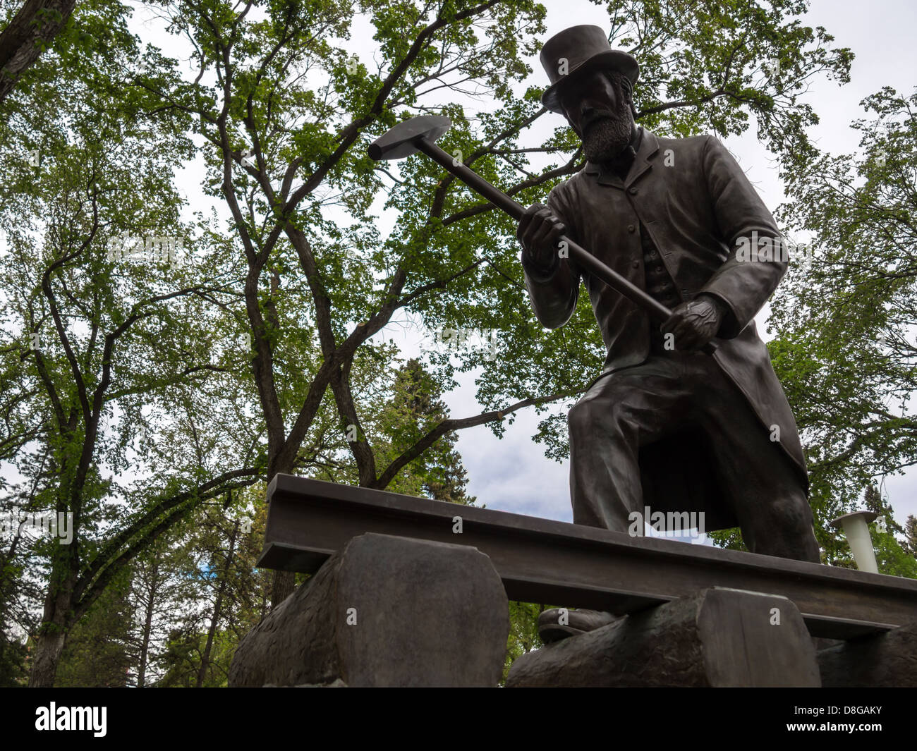 statue of man holding hammer working on railroad in Edmonton Stock ...