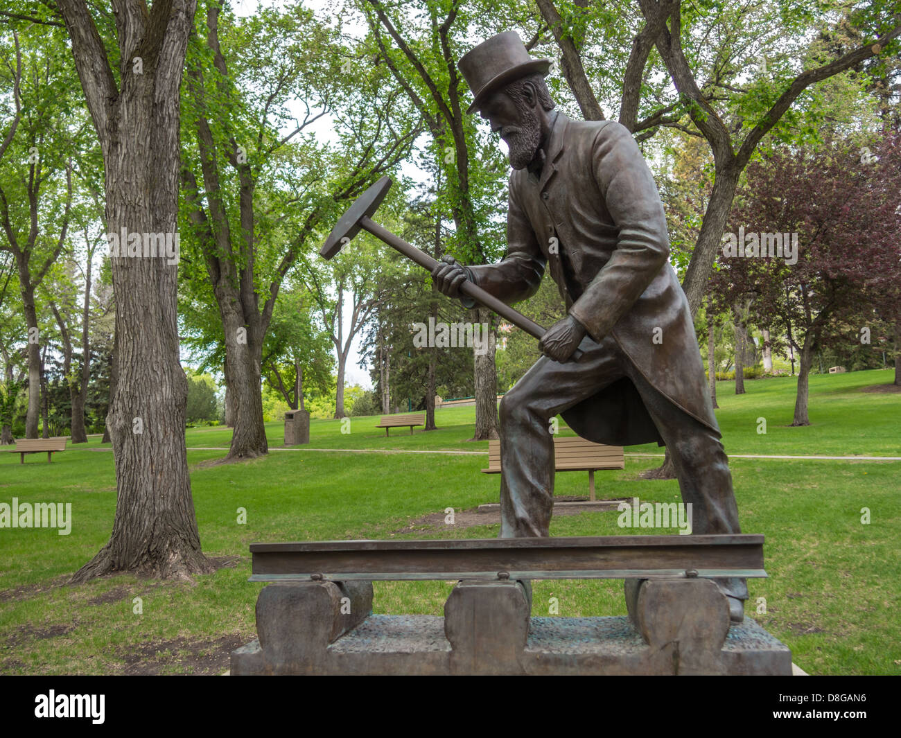 statue of man holding hammer working on railroad in Edmonton Stock ...