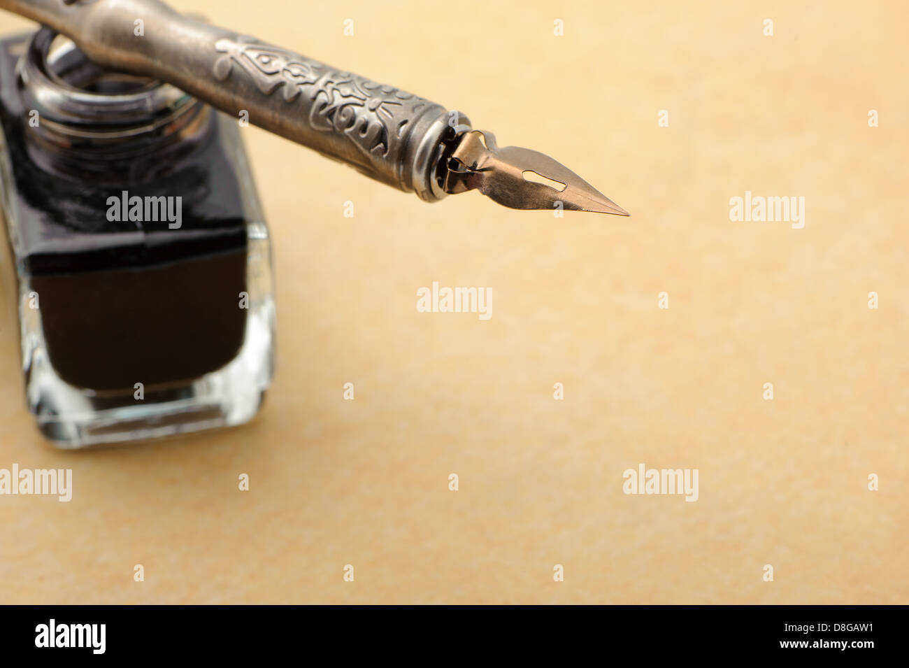 Feather quill and inkwell on an old paper Stock Photo - Alamy