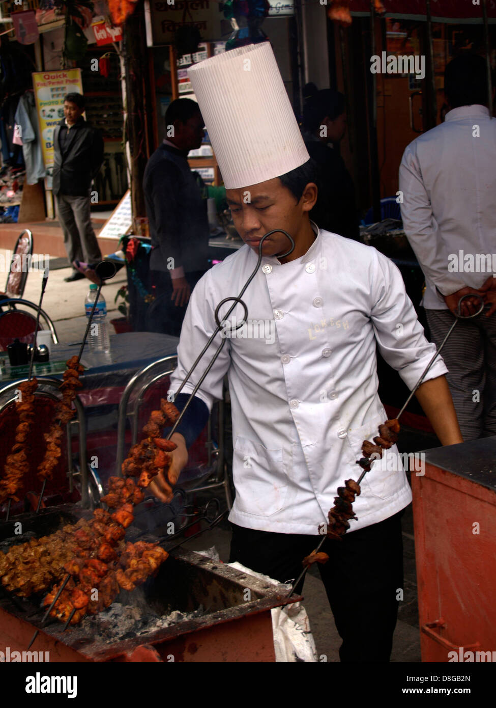 A chef cooking shish kabob at a street festival in Phokara, Nepal Stock ...