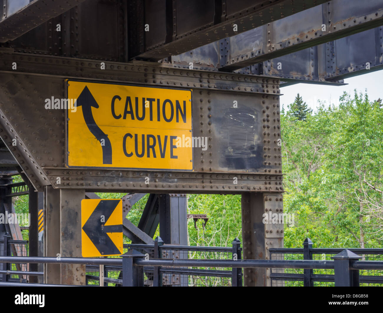 Road sign "Caution Curve" on a rusty bridge. High Level bridge in ...