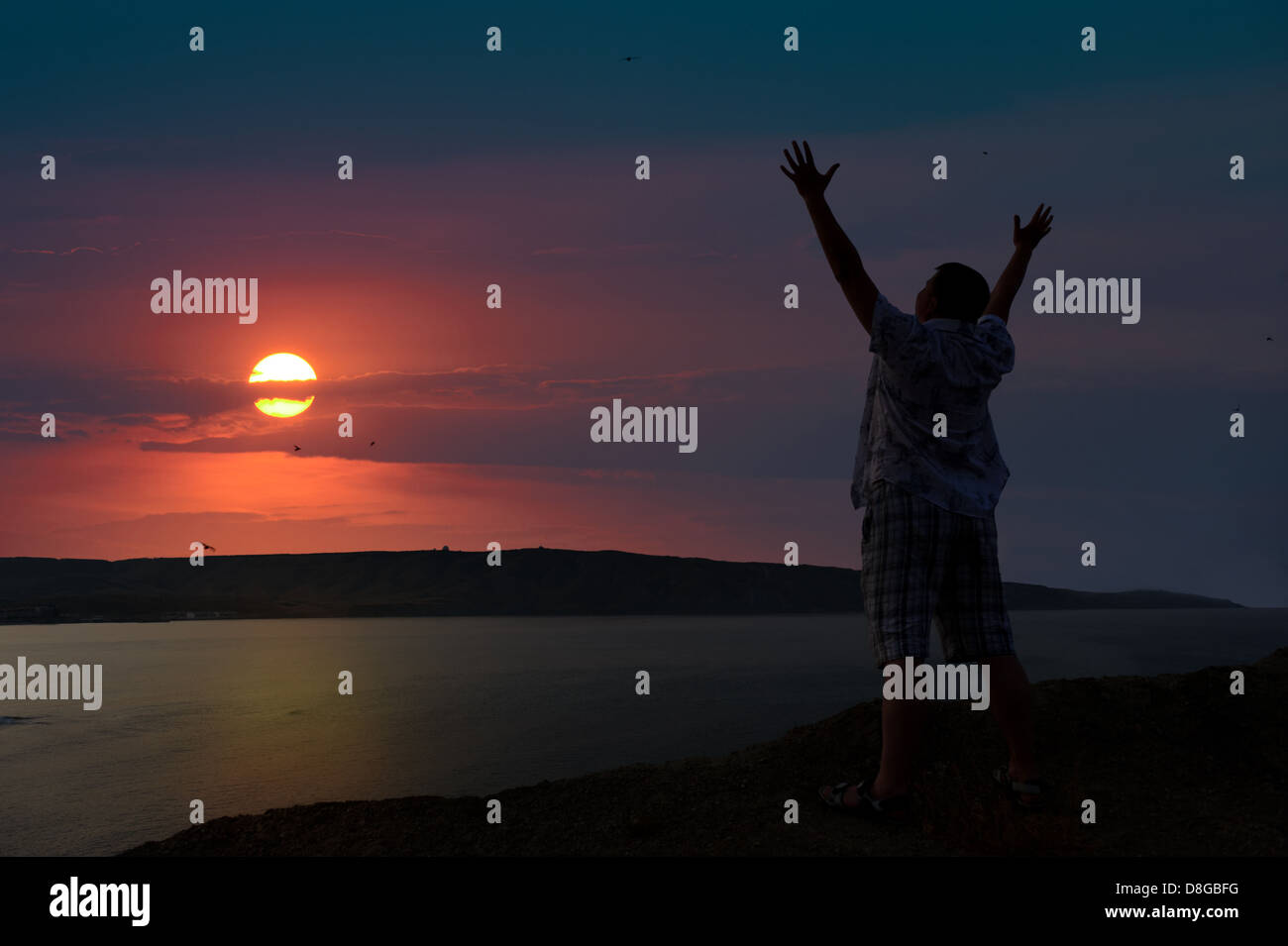 The man welcomes the sunset sun Stock Photo - Alamy