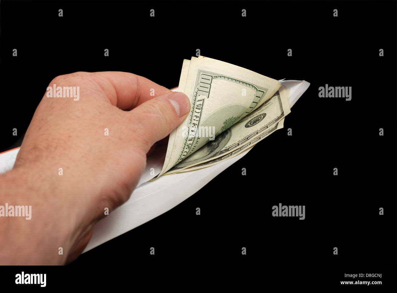 Bribe in an envelope and hand Stock Photo - Alamy