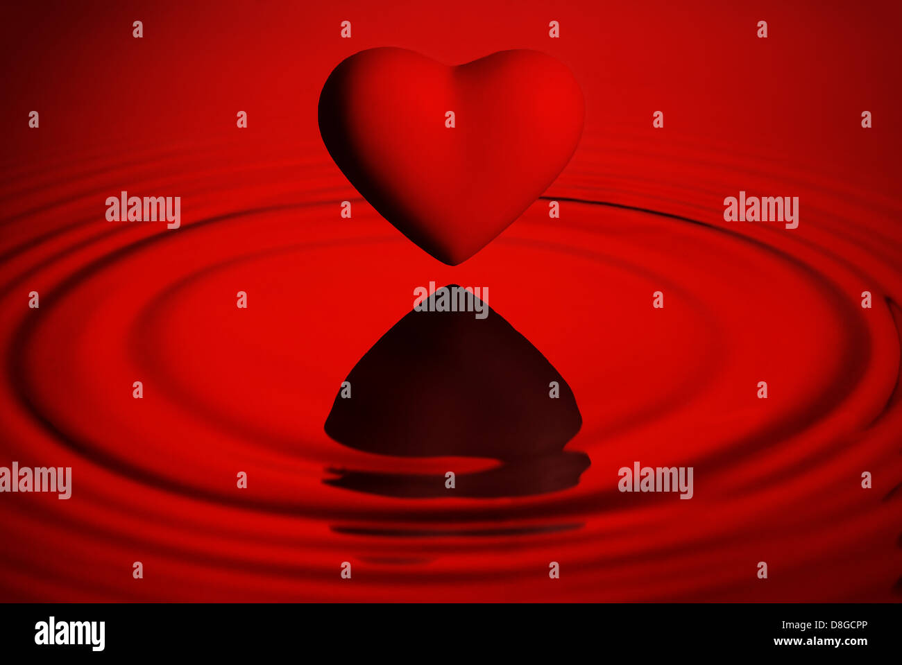 Red heart over water ripples Stock Photo - Alamy