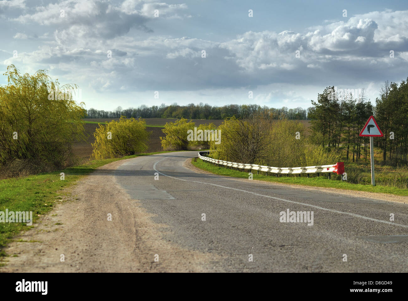 Landscape with road turning Stock Photo - Alamy