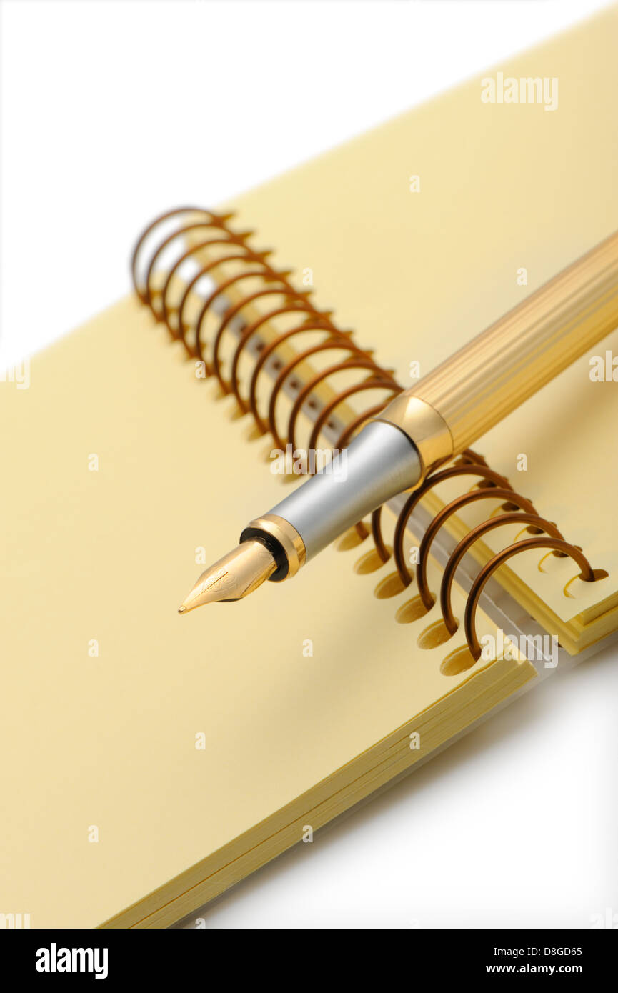 Fountain pen on a yellow notebook Stock Photo - Alamy
