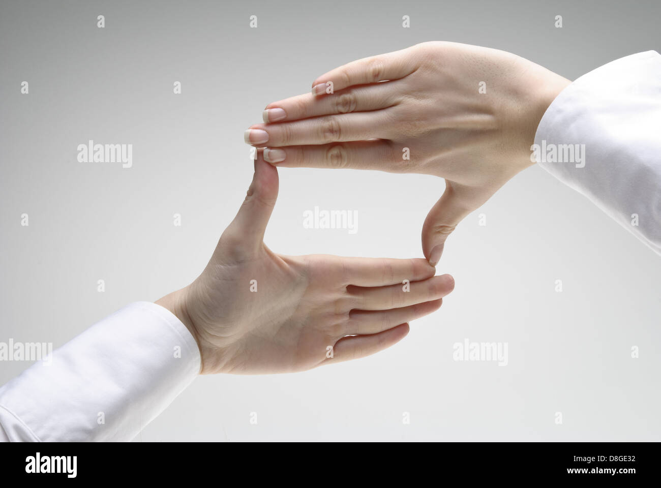 Woman's hand showing crop symbol Stock Photo - Alamy