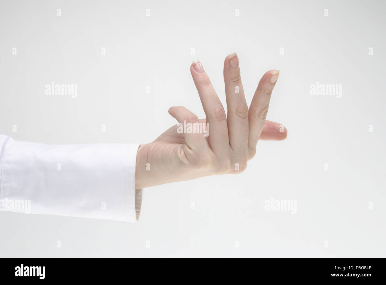 Woman's hand making gesture Stock Photo - Alamy
