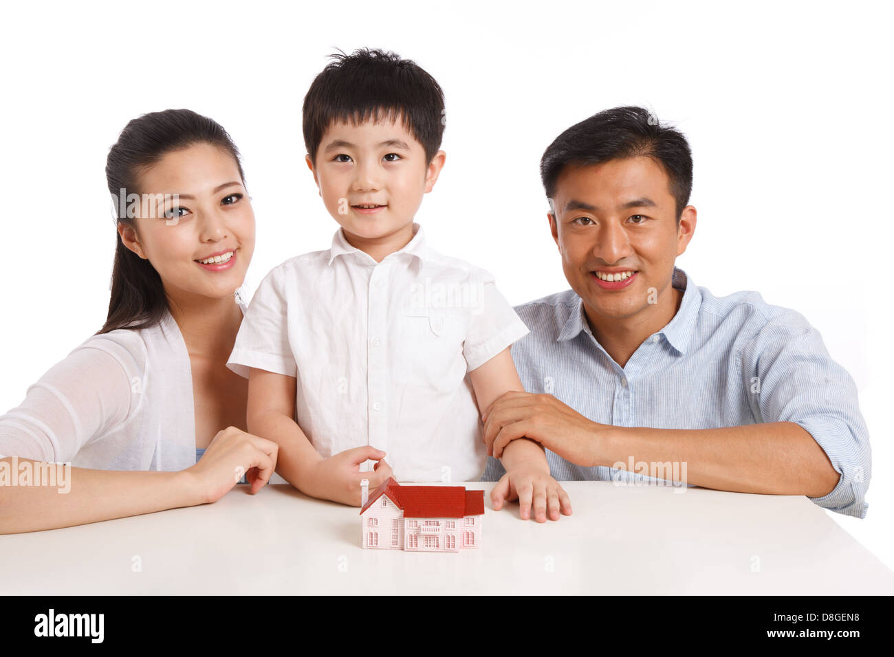 Family with house model Stock Photo - Alamy