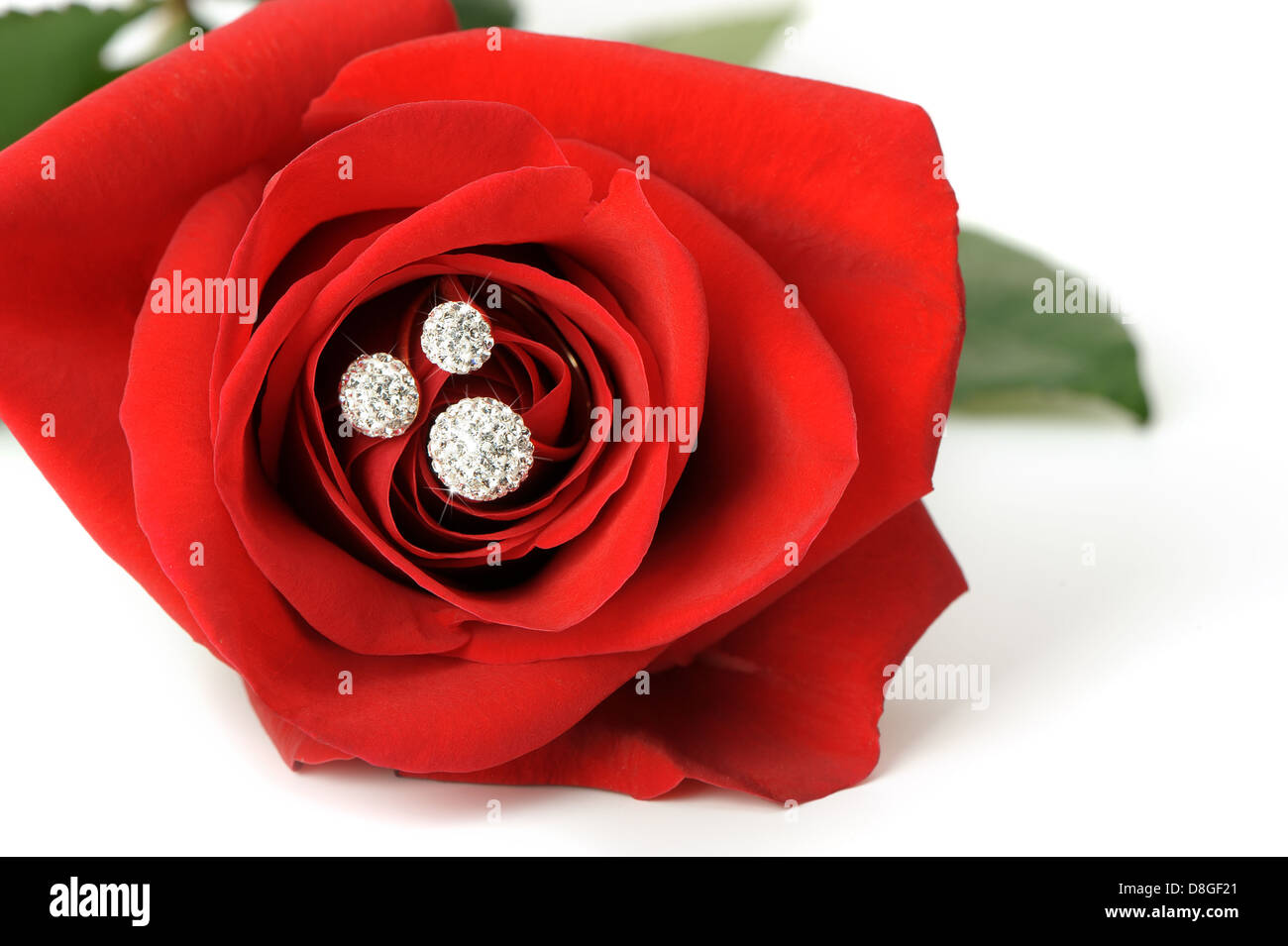 Red rose with a ring with jewels Stock Photo - Alamy