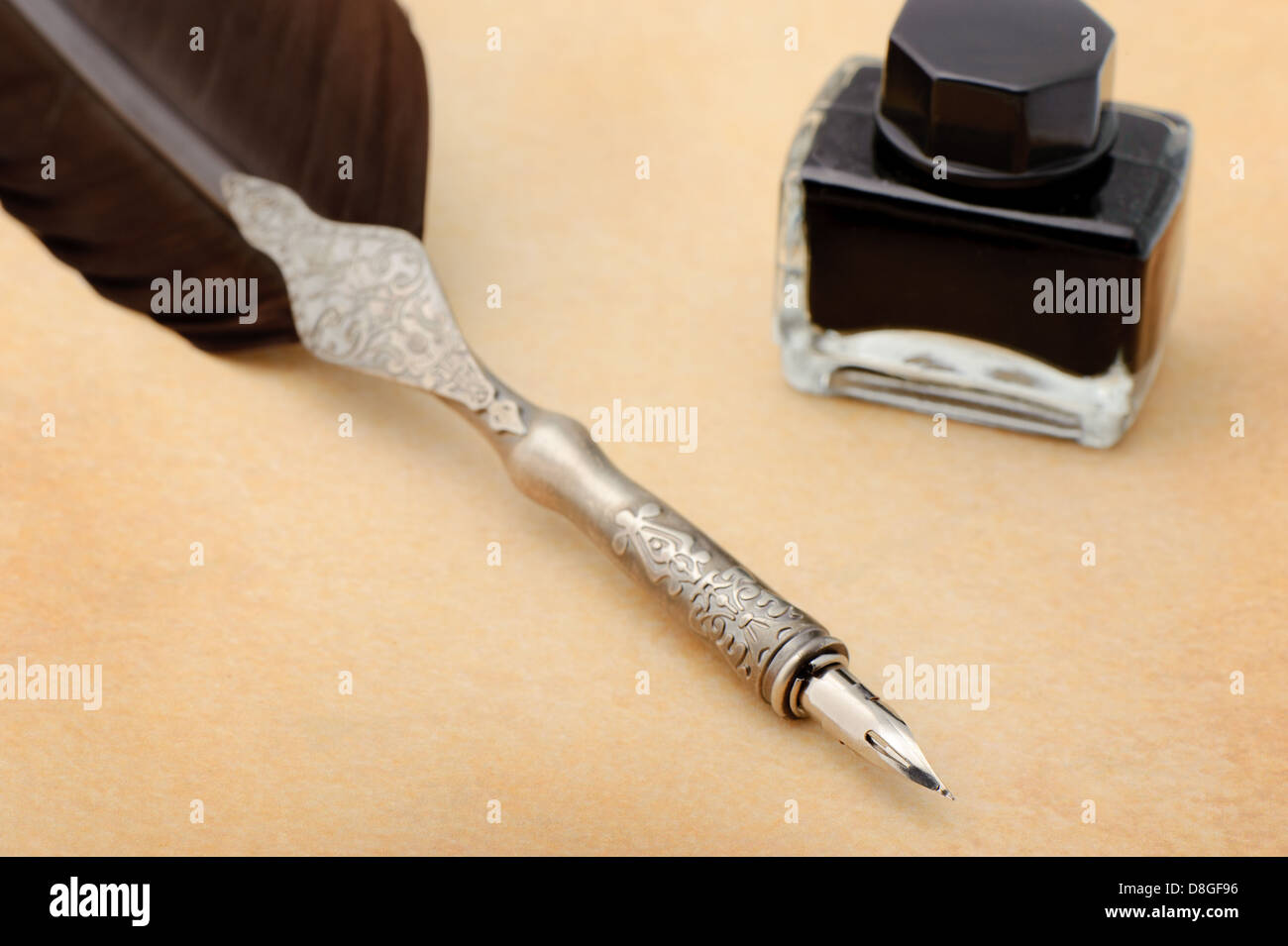 Feather quill and inkwell on an old paper Stock Photo - Alamy