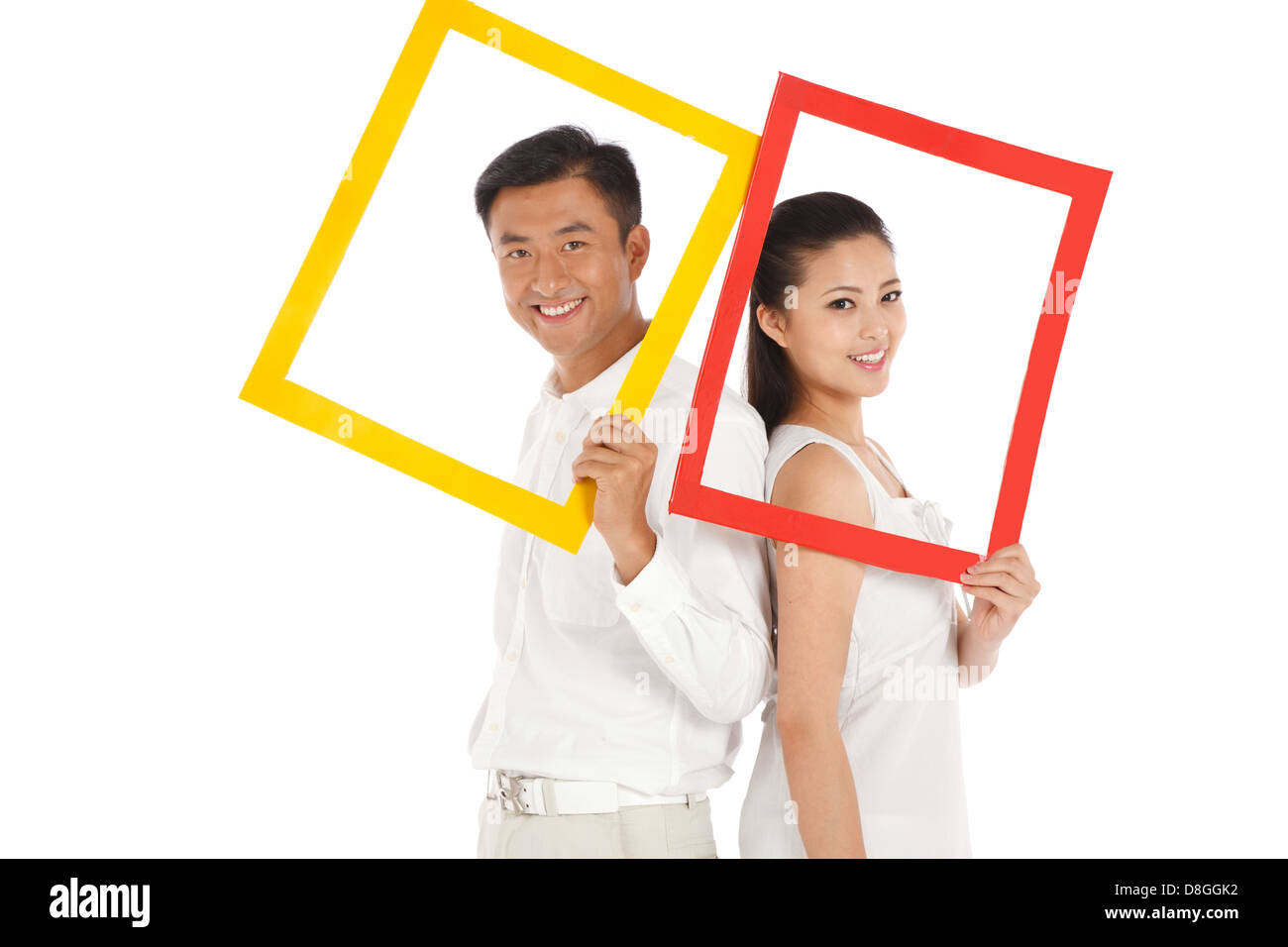Young couple holding photo frame Stock Photo - Alamy