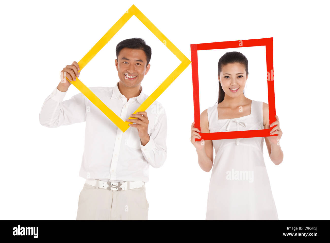 Young couple holding photo frame Stock Photo - Alamy