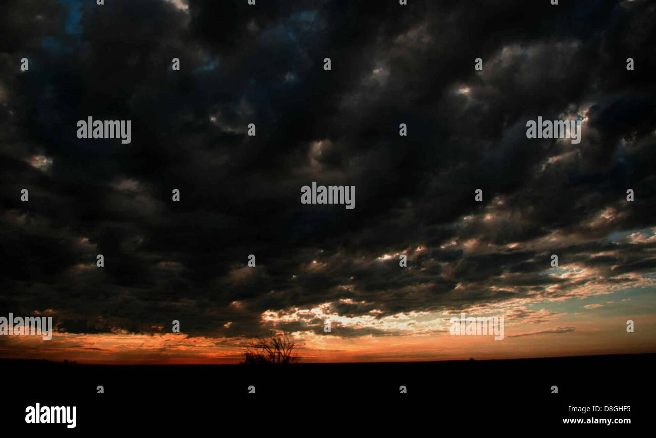 This image shows a dramatic dark black sky, possibly during twilight or ...