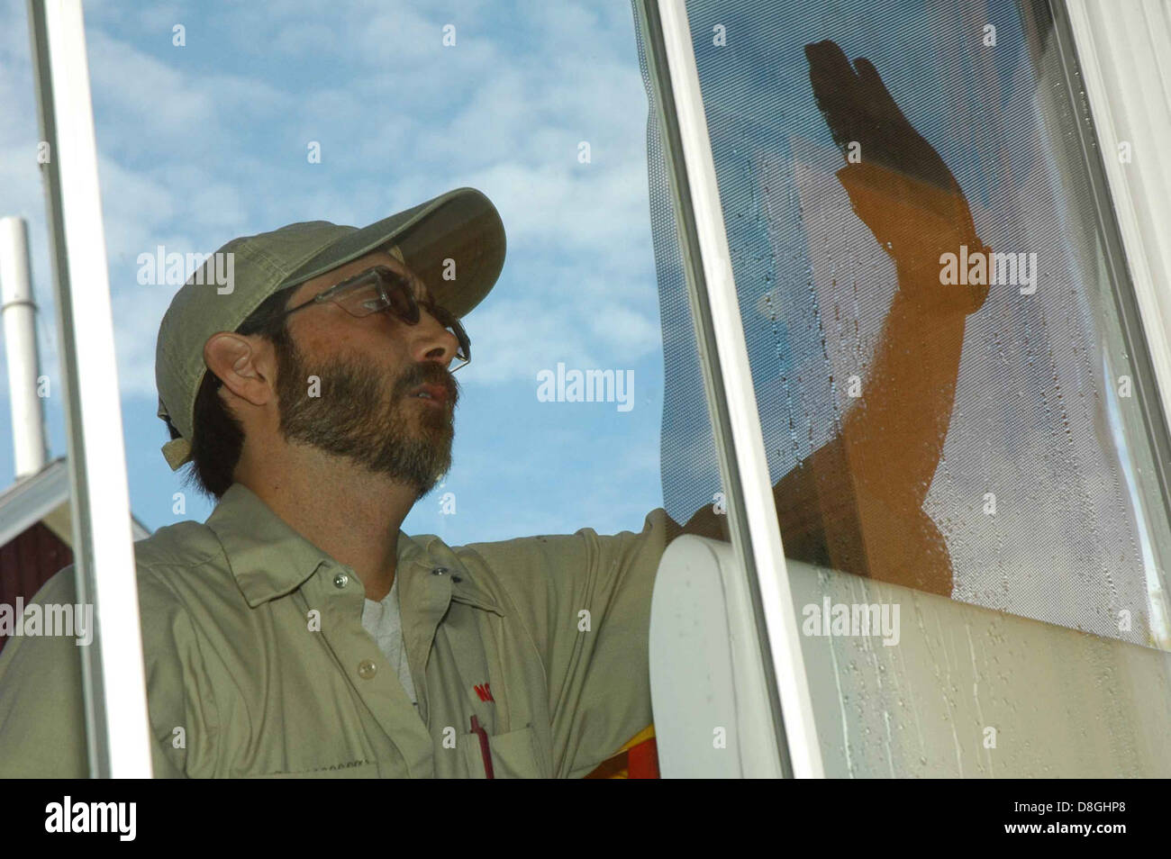 A technician applies an anti-bird strike film to a plane’s window. The ...