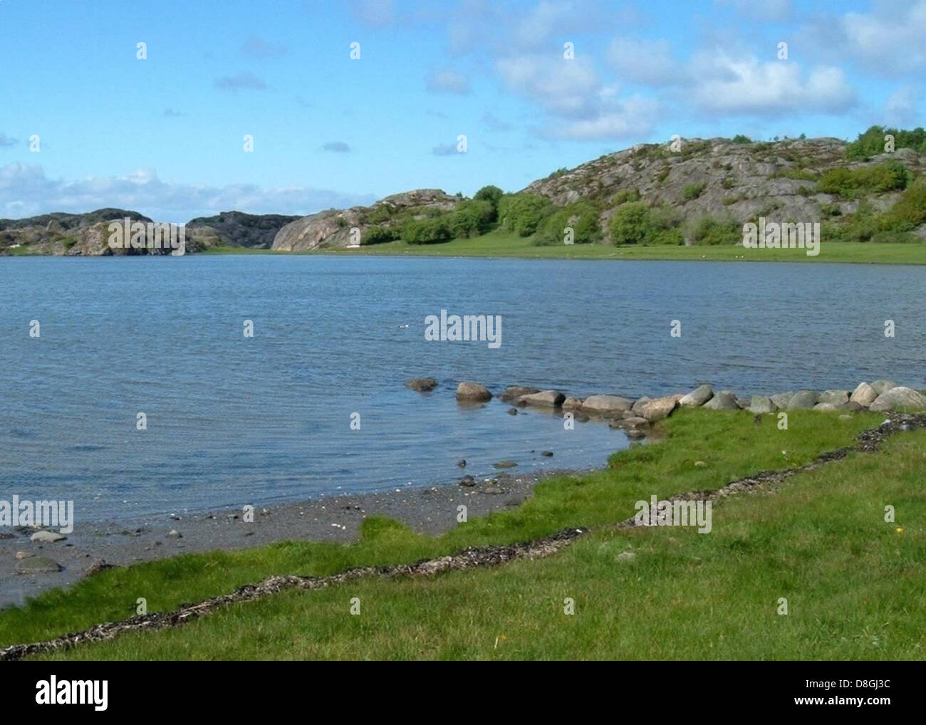A scenic view of a bay surrounded by a group of small islands, creating ...