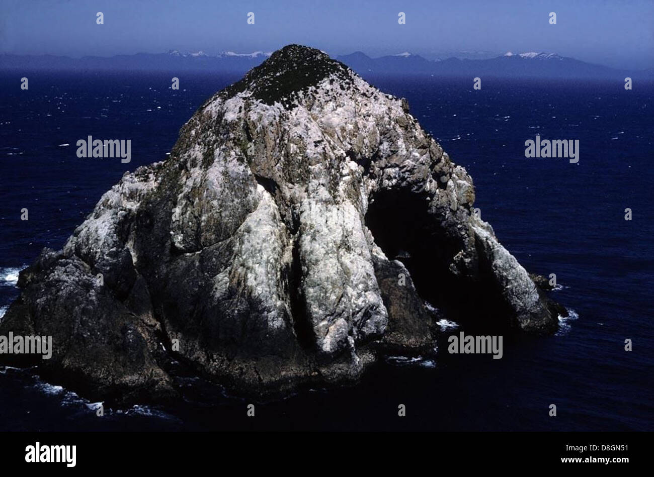 Big hazy islet cliff Stock Photo - Alamy