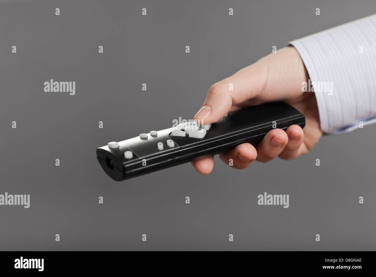 Human hand holding tv channel remote control Stock Photo - Alamy