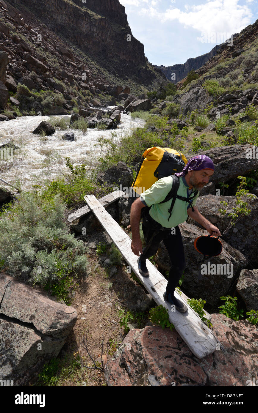 Portaging gear around Jarbidge Falls on Idaho's Jarbidge River Stock ...