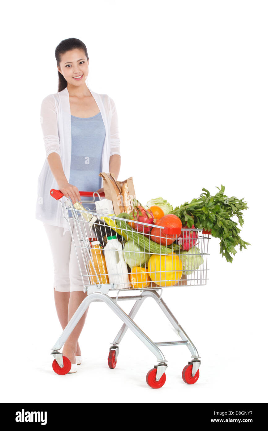 Young woman shopping with shopping cart Stock Photo - Alamy