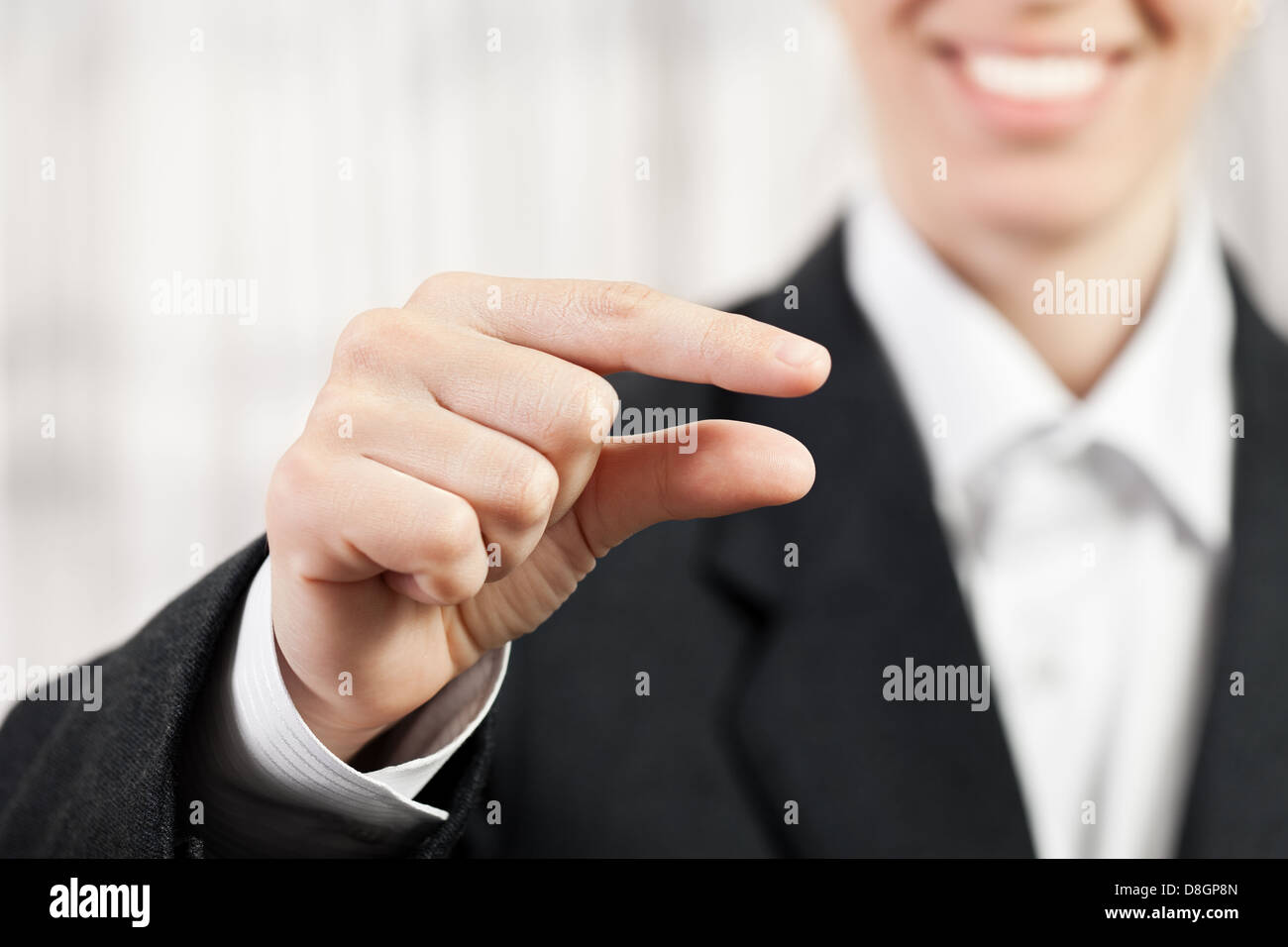 Businesswoman pinching finger sign Stock Photo - Alamy
