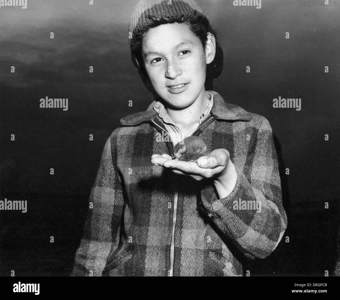 An old photograph of a boy, likely taken in earlier decades, capturing ...